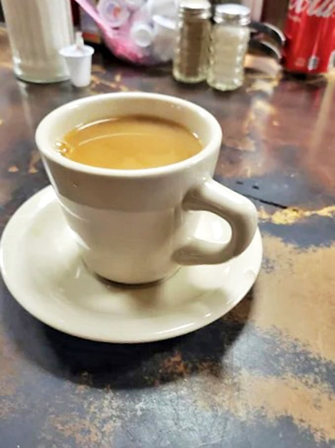 Coffee in a proper diner mug, the kind that stays hot, tastes right, and gets refilled before you even realize you need it.
