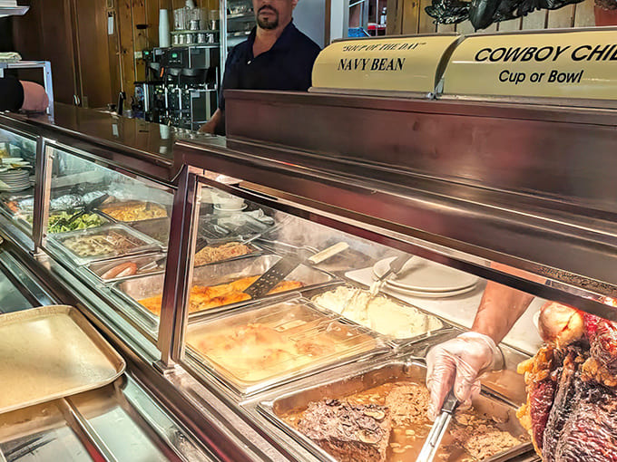 The cafeteria line reveals an array of freshly prepared dishes, where seeing is believing and choices abound for hungry patrons.