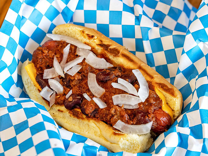 A chili dog that means business &ndash; topped with homestyle chili, diced onions, and melted cheese, it's gloriously messy and worth every napkin.