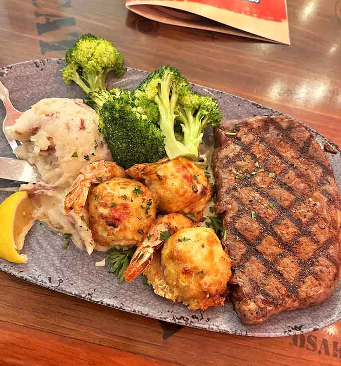 Steak and stuffed shrimp share the plate in perfect harmony, proving that surf and turf isn't just a pairing – it's a culinary soulmate situation.