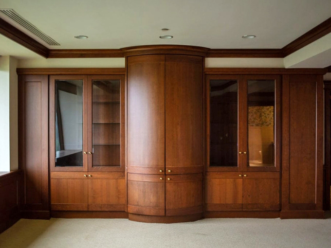 Even the interior cabinetry maintains the warm wood aesthetic. No plastic bins here&mdash;everything stays on brand with rich cherry finishes.