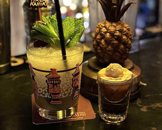 Talk about a power couple! The golden Mai Tai stands tall while its companion, a Banana Foster shot, waits to deliver its caramelized sweetness.