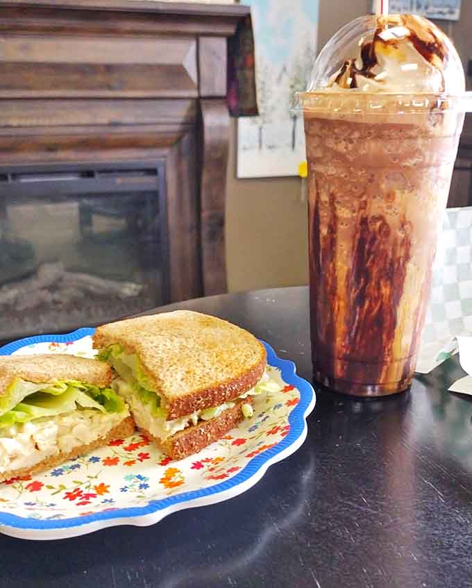 The perfect pairing: a hearty sandwich and a frozen coffee drink that's basically dessert in disguise, and we're here for it.