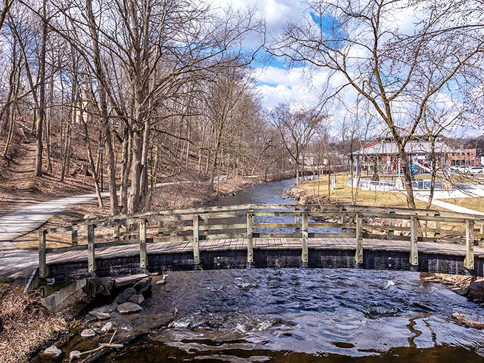 Wooden footbridges cross gentle streams, offering peaceful moments of reflection amid Plymouth's natural beauty.