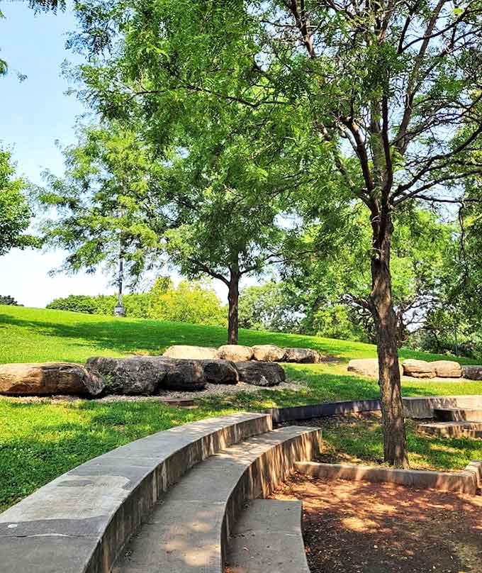 Stone seating curves gracefully through the landscape, offering perfect perches for people-watching or contemplating which yellow brick road to follow next.