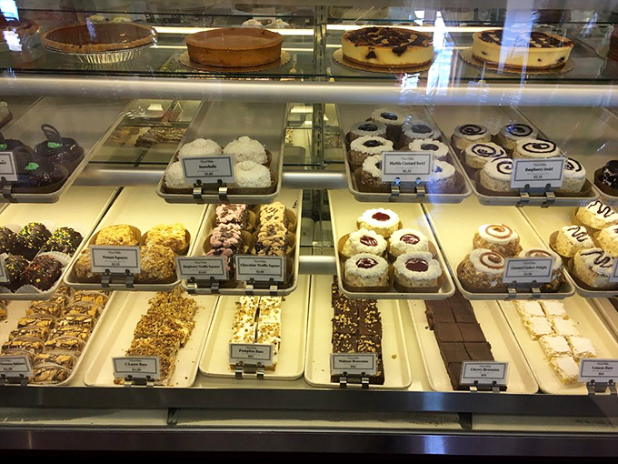 The display case reveals layer upon layer of temptation, from classic cookies to elaborate pastries that make diets disappear faster than the treats themselves.