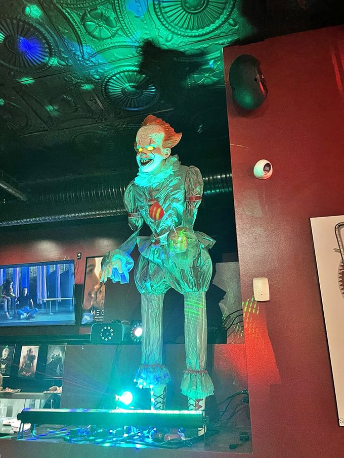 The eerie green glow illuminating this creepy clown figure creates the perfect backdrop for your meal &ndash; he's just waiting for you to try the dessert.