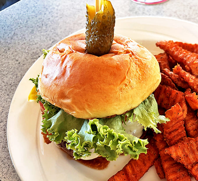 Not just any burger &ndash; this beauty comes with all the fixings and a pickle spear standing tall like a ship's mast.