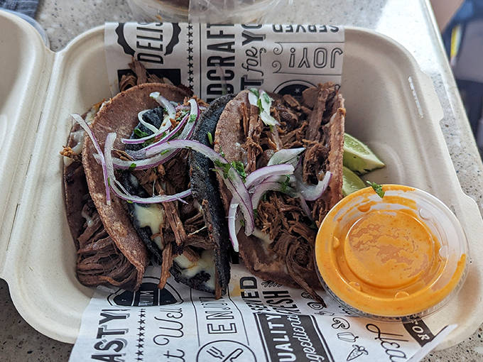 Crispy, cheese-crusted tortillas hiding tender beef inside &ndash; dip them in that vibrant orange consomm&eacute; for a flavor explosion.