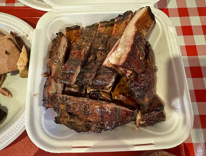 This isn't just a rack of ribs; it's architecture. The structural integrity of that bark supporting meat that's ready to surrender to your bite.
