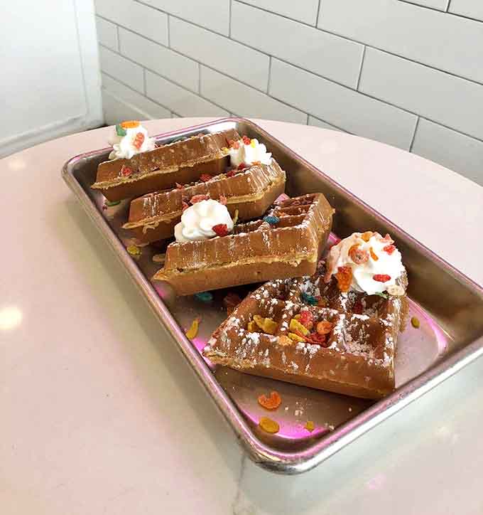 Fruity Pebbles waffles arrive looking like edible art, proving that breakfast foods deserve to party together at all hours of the day.