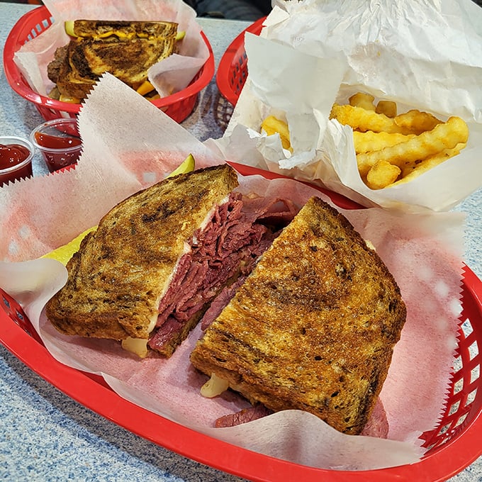 A perfectly grilled Reuben sandwich that's piled high enough to require air traffic control &ndash; paired with those signature crinkle fries.