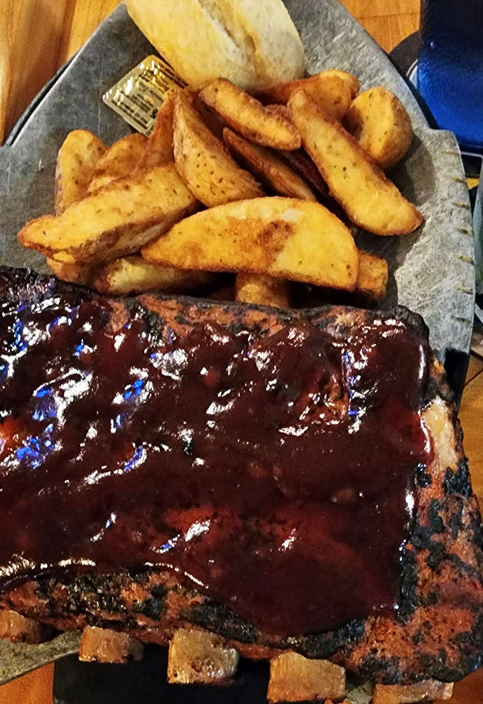 Fall-off-the-bone ribs glazed with house barbecue sauce alongside crispy potato wedges &ndash; no fancy presentation needed when it tastes this good.