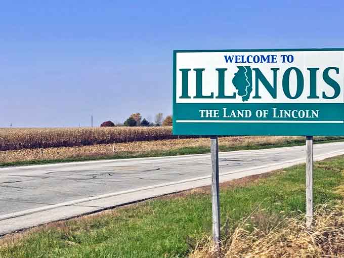 Against golden prairie grass, the welcome sign offers a first glimpse of Illinois's agricultural heritage stretching to the horizon.