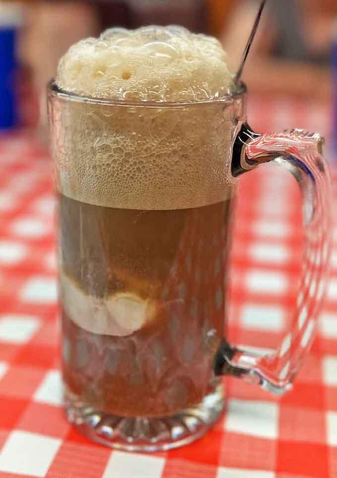 The root beer float arrives in a frosted mug, creating that perfect foam cap that makes you wonder why we ever complicated beverages.