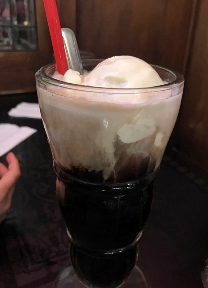 This root beer float shows off its classic two-tone composition like a delicious science experiment you're absolutely allowed to drink with enthusiastic slurping sounds.