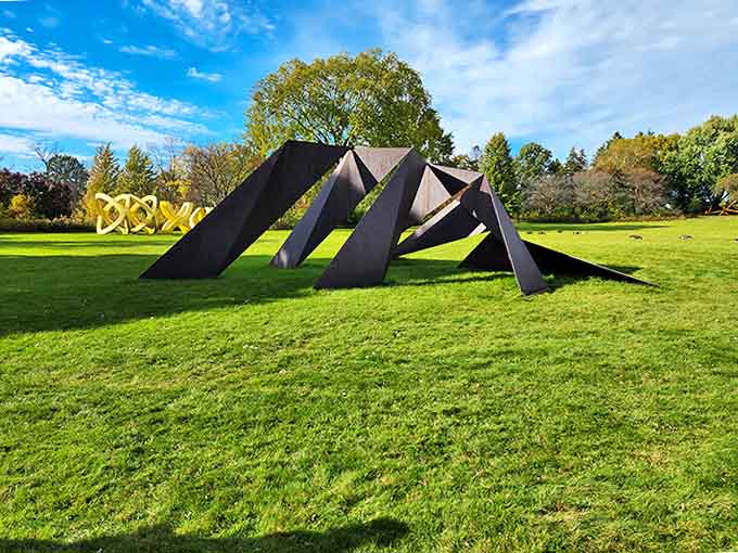 Sharp angles of this black sculpture create a visual puzzle that changes dramatically as you circle it, like origami frozen in metal.
