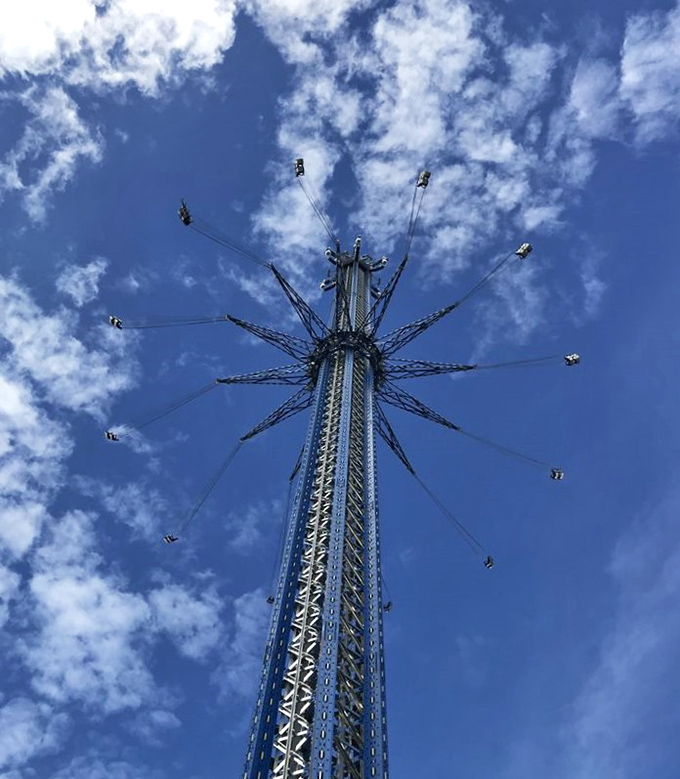 The moment of truth as riders soar through Orlando's atmosphere, creating a human constellation around the towering blue spire.