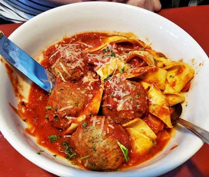 These aren't your average meatballs &ndash; they're hefty, herb-flecked spheres of delight nestled in fresh pasta and swimming in a robust tomato sauce that simmered to perfection.