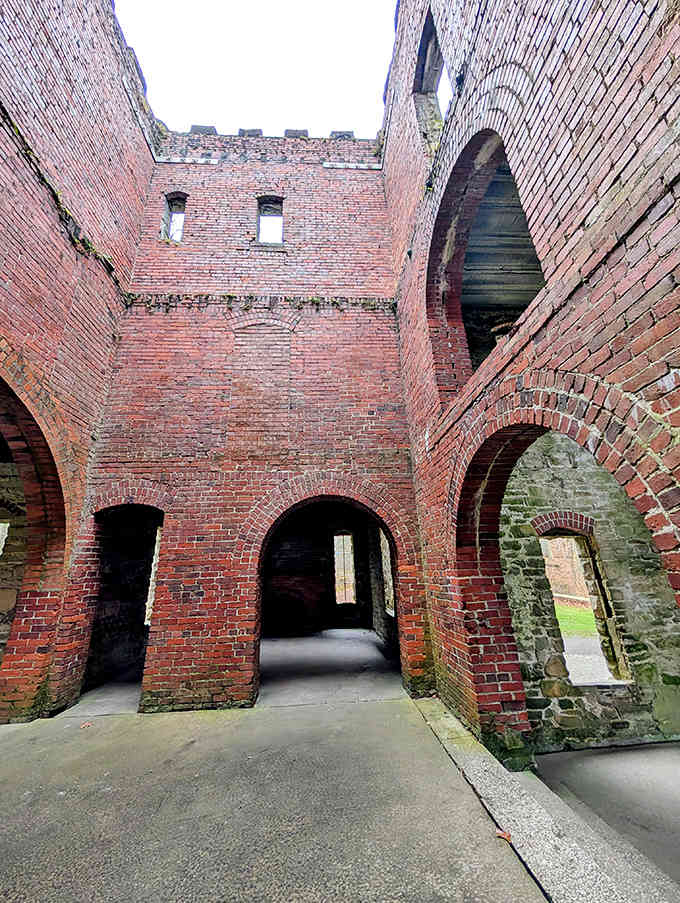 The castle's interior remains an empty canvas for imagination, with stone walls framing views of the surrounding forest like living paintings.