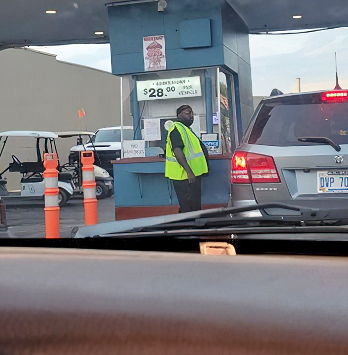 Staff efficiently process vehicles at the entrance booth, where the excitement of movie night begins.