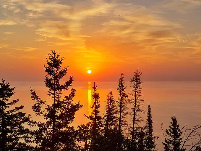Sunset paints the sky in impossible colors, turning Lake Superior into a mirror that doubles the magic of twilight.