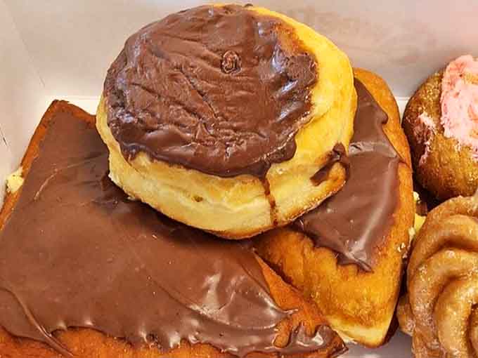 The chocolate-topped beauties glisten under bakery lights &ndash; proof that sometimes the universe does actually love us and wants us to be happy.