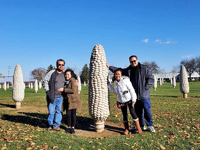 Visitors pose with their favorite corn ear, creating vacation photos that definitely won't be confused with anyone else's summer memories.