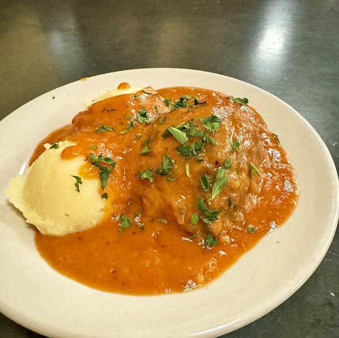 Ukrainian meatballs swimming in tomato cream sauce alongside fluffy mashed potatoes &ndash; comfort food that transcends cultural boundaries.