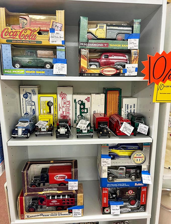 Miniature automotive history parks on these shelves, where die-cast dreams in pristine packaging await collectors with gasoline in their veins.