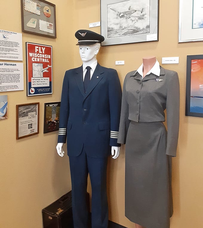 Vintage airline uniforms stand at attention, showcasing the evolution of aviation style from utilitarian beginnings to the golden age of air travel.