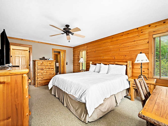 Bedroom or sanctuary? Pine walls cocoon you while plush bedding promises the kind of sleep city dwellers have forgotten exists.