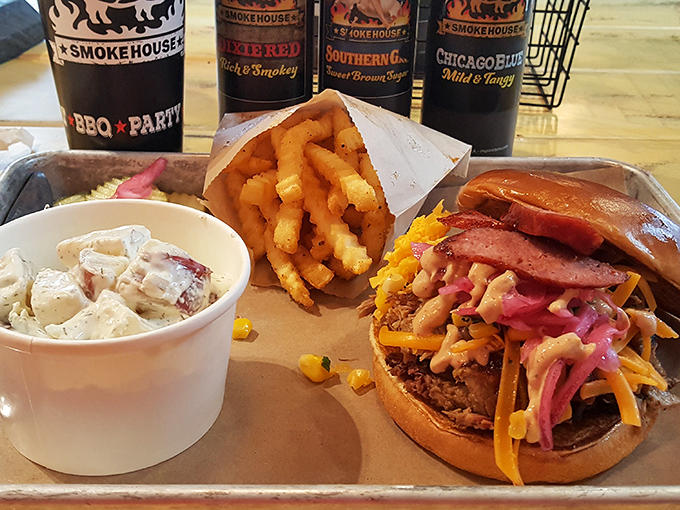The complete BBQ experience: sandwich, fries, and slaw creating the holy trinity of comfort food that speaks directly to your soul.