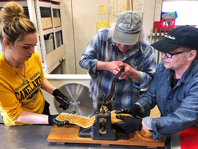 Candy-making magic in action! This vintage roller machine transforms sweet dough into perfectly shaped treats before your eyes.