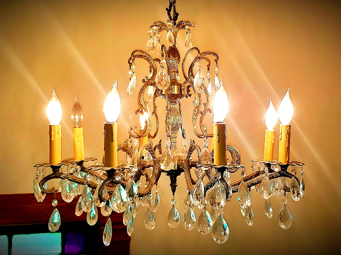 Crystal teardrops cascade from brass arms in this stunning chandelier &ndash; illuminating dinner conversations about time travel and alternate histories.