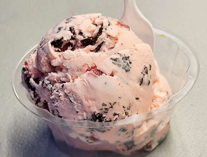 Cherry ice cream so vibrant it looks like it's blushing from all the attention it's getting.