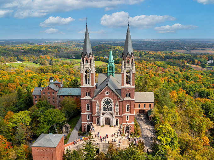 Holy Hill Basilica rises majestically above the autumn landscape, twin spires reaching toward heaven like a postcard from Europe.