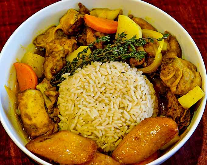 Curry chicken that proves sometimes the most beautiful things in life come in humble bowls surrounded by simple vegetables.