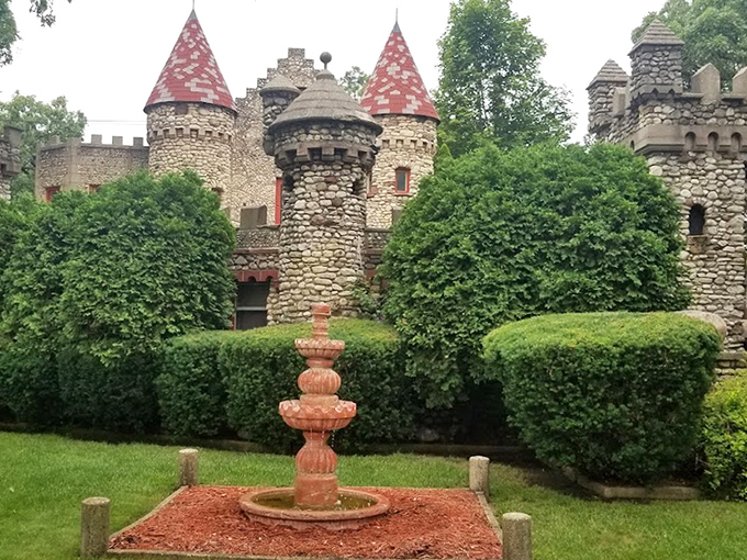 A simple stone fountain adds tranquility to the castle grounds, offering a peaceful spot to contemplate how this medieval marvel landed in the Midwest.