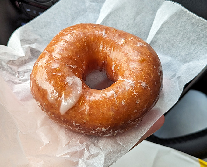 The humble glazed donut, perfected &ndash; a pillowy cloud of dough wrapped in a sweet sheen that shatters delicately with each bite.