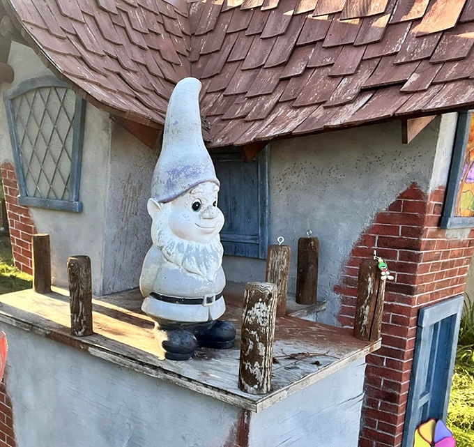 The village guardian stands watch, his pointy hat and knowing smile suggesting he's seen a few things in his time.