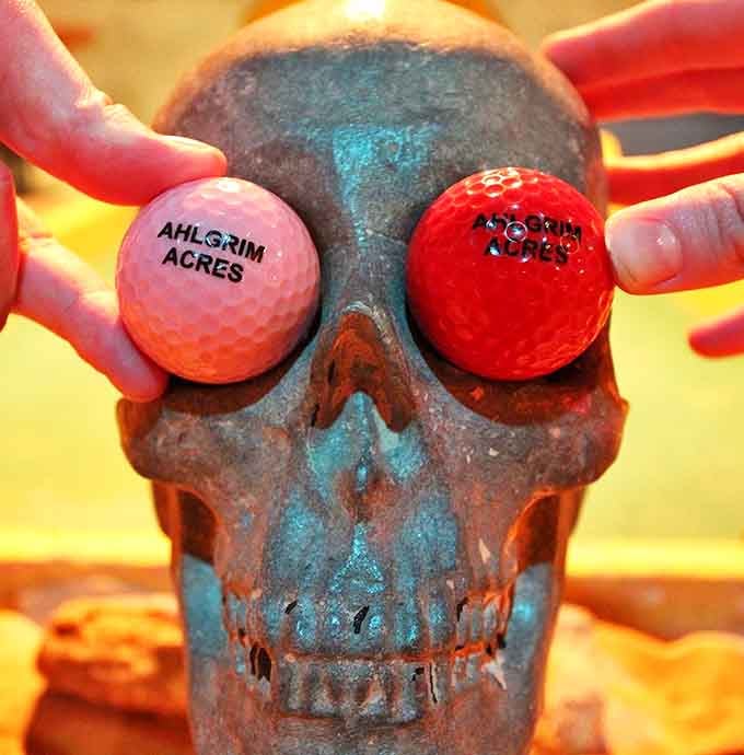 Even the golf balls get into the spirit here, sporting custom branding that perfectly captures the course's playful darkness.
