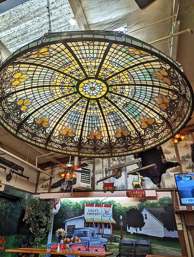 Sunlight filters through this salvaged architectural masterpiece, casting kaleidoscope patterns that transform ordinary shopping into a cathedral-like experience.