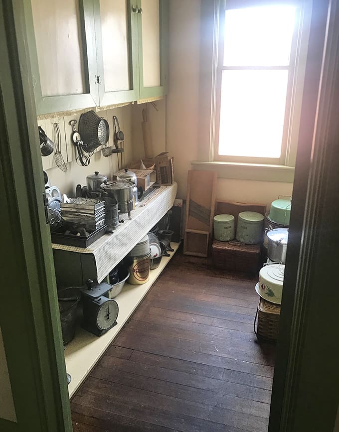 This kitchen snapshot reveals America's culinary past – cast iron, enamelware, and manual tools from when cooking was an art form.