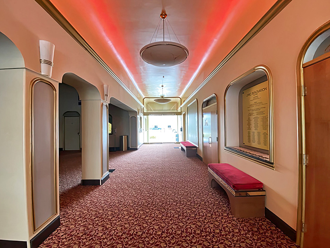 The corridor's elegant carpet and vintage-inspired lighting make even a trip to your seat feel like walking through a more glamorous era.