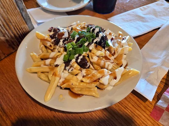 Poutine gets a smoky makeover &ndash; crispy fries smothered in cheese, gravy, and enough toppings to make Canadians nod in approval.