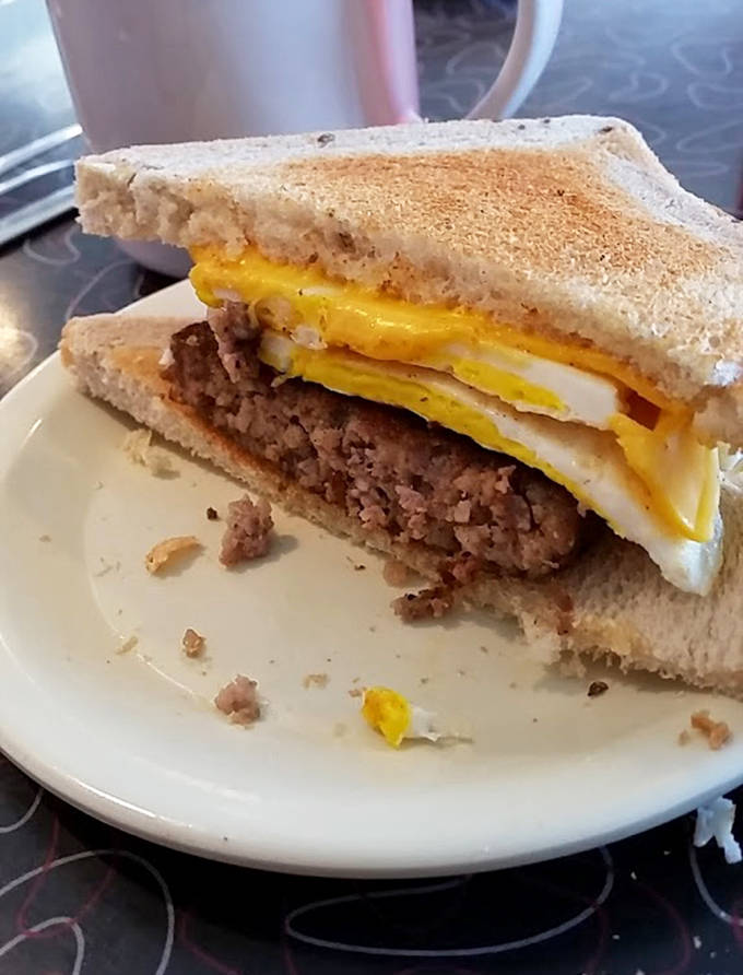 Breakfast sandwiches stacked high with egg, meat, and cheese &ndash; portable perfection that requires strategic eating and extra napkins.