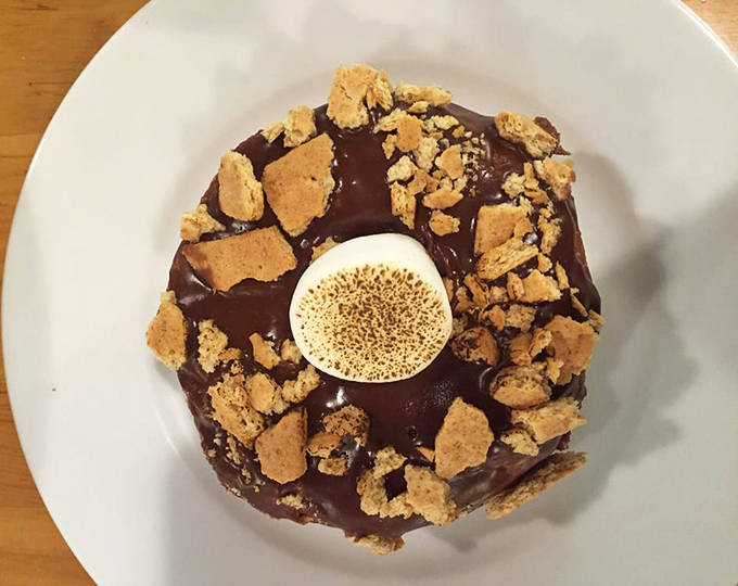 S'mores in donut form! The toasted marshmallow center and chocolate-graham cracker topping capture campfire magic without the mosquito bites.