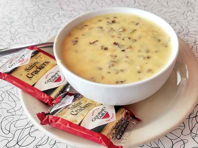 The chicken wild rice soup arrives with crackers standing guard &ndash; a creamy Minnesota tradition that warms from the inside out.