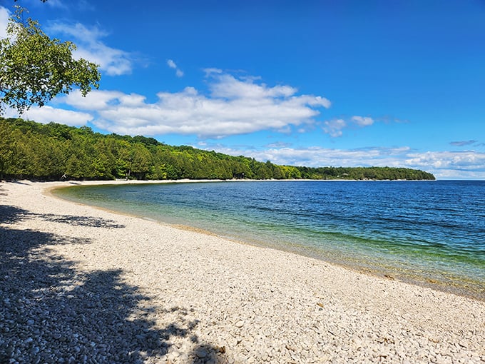 The curve of the shoreline creates a natural embrace, holding visitors in a pocket of tranquility.
